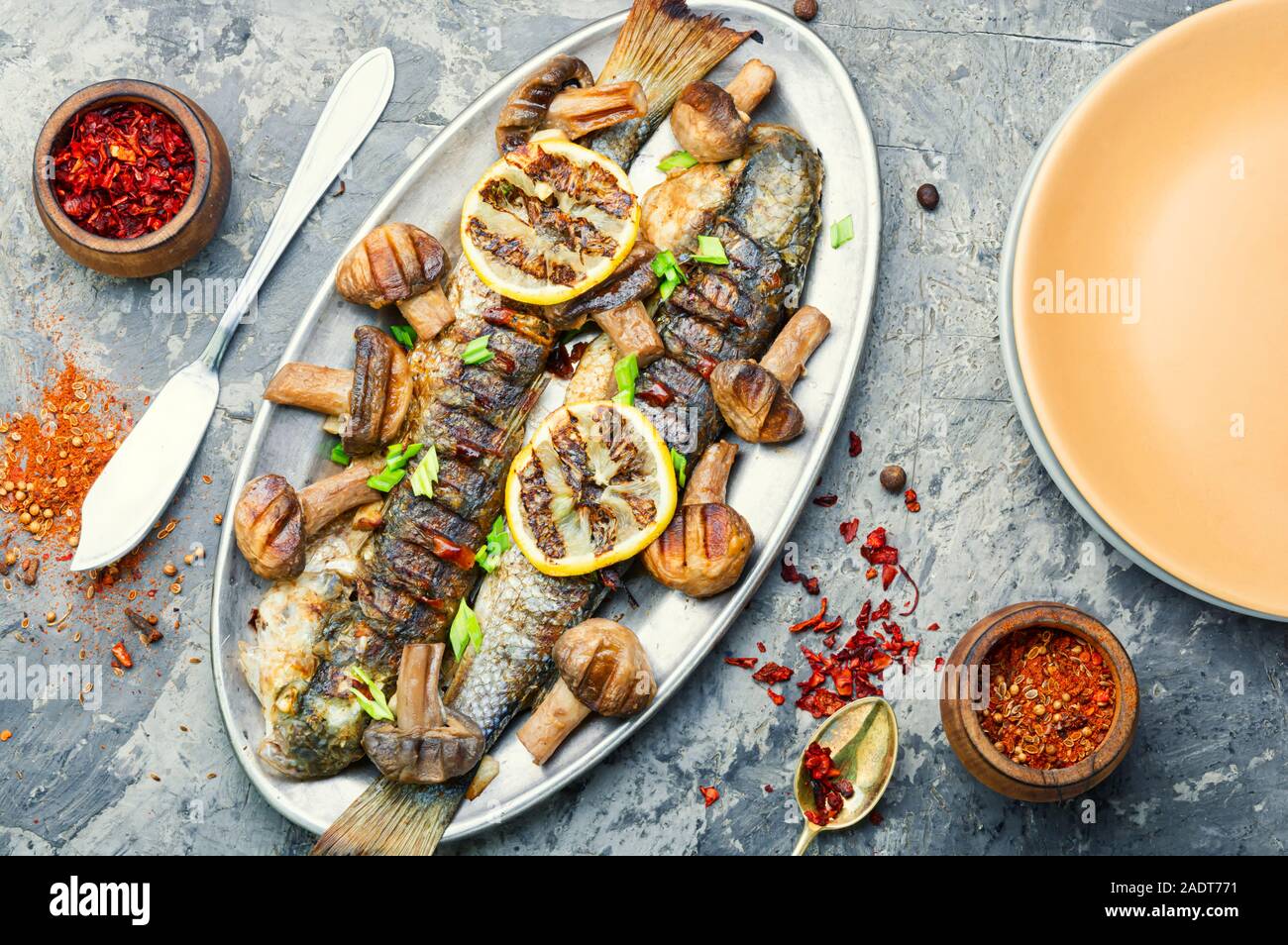 Roasted pelengas fish with mushrooms and lemon.Sea food.Grilled fish ...