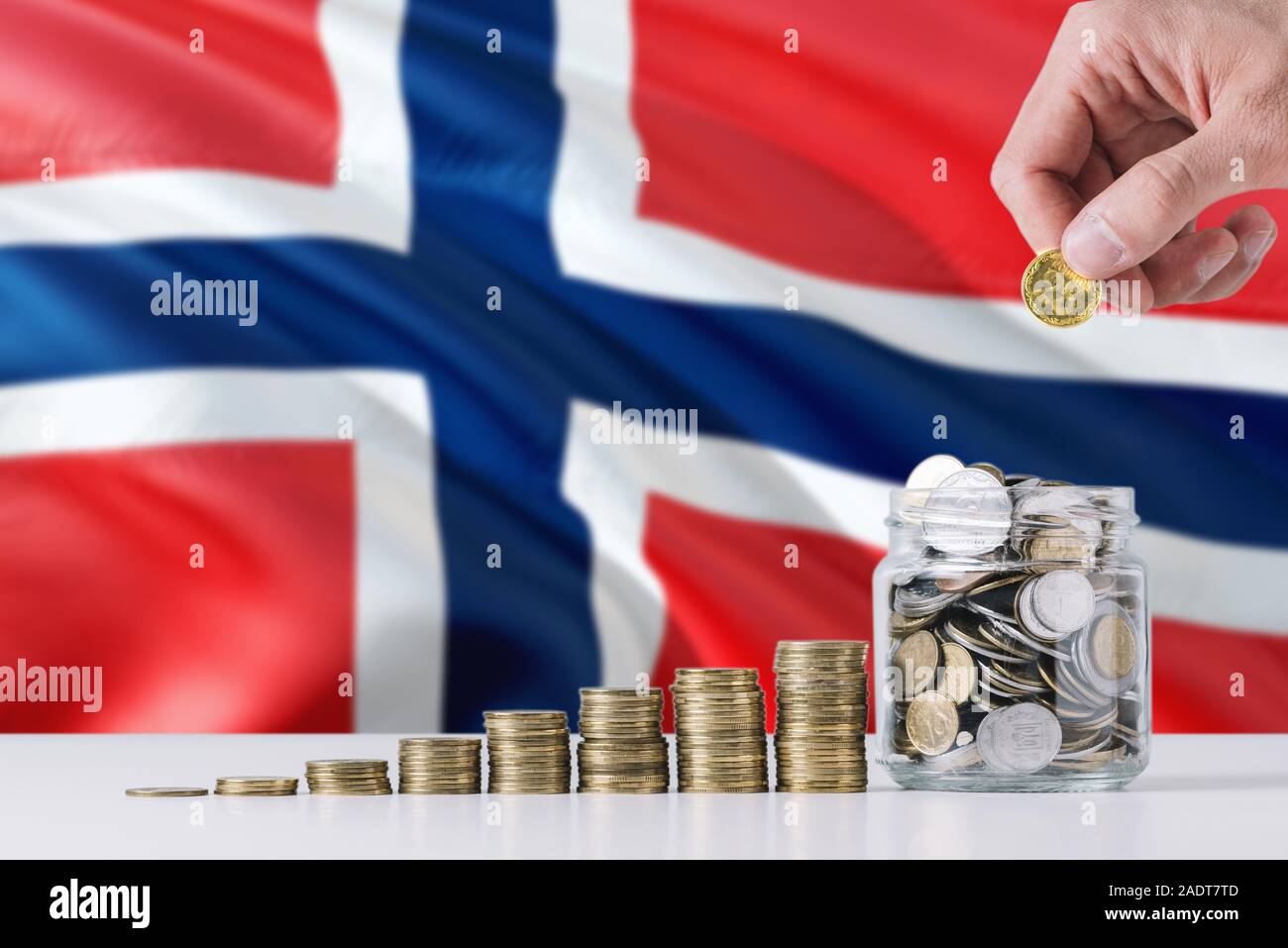 Business man holding coins putting in glass, Norway flag waving in the ...