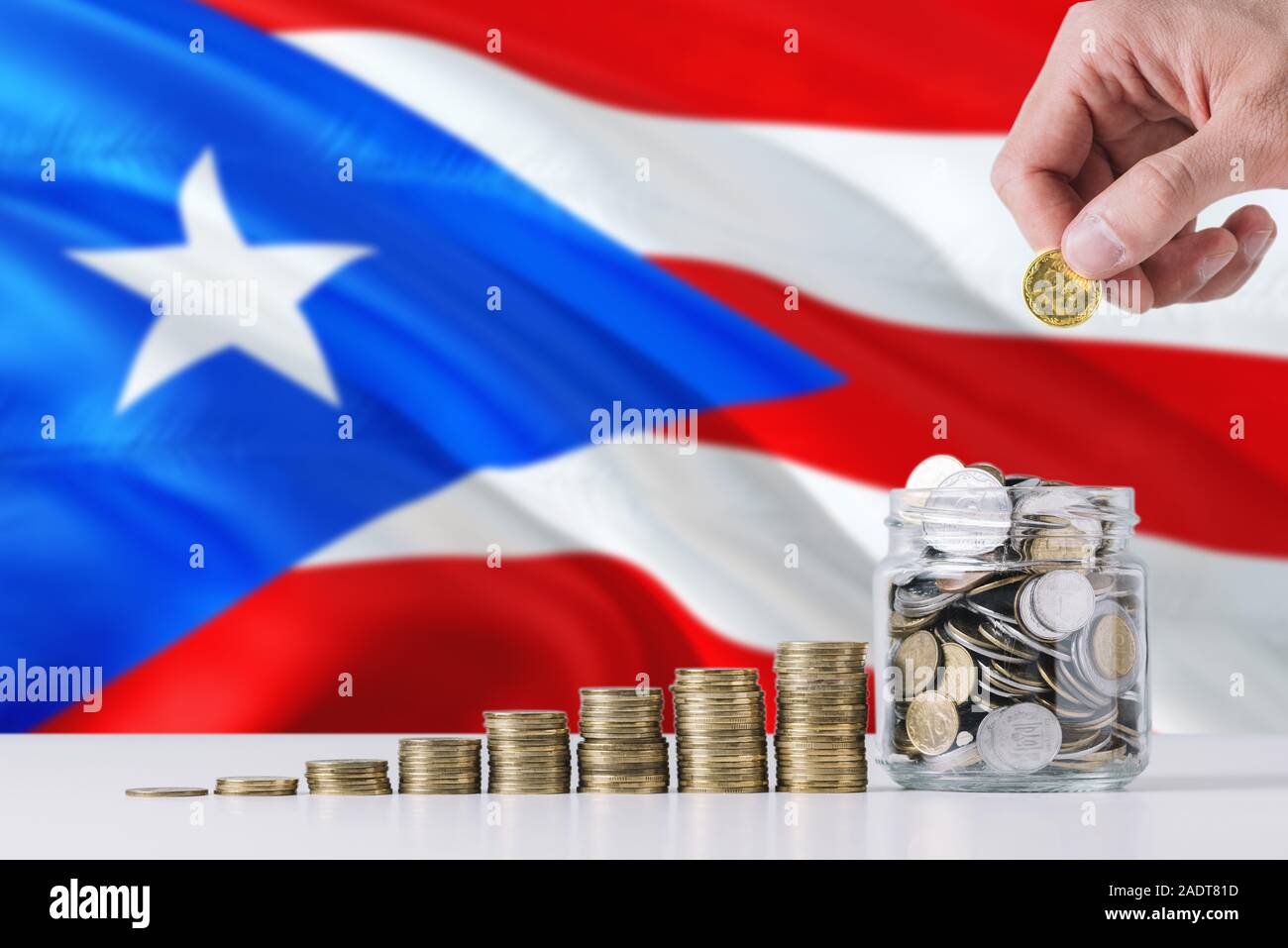 Business man holding coins putting in glass, Puerto Rico flag waving in ...