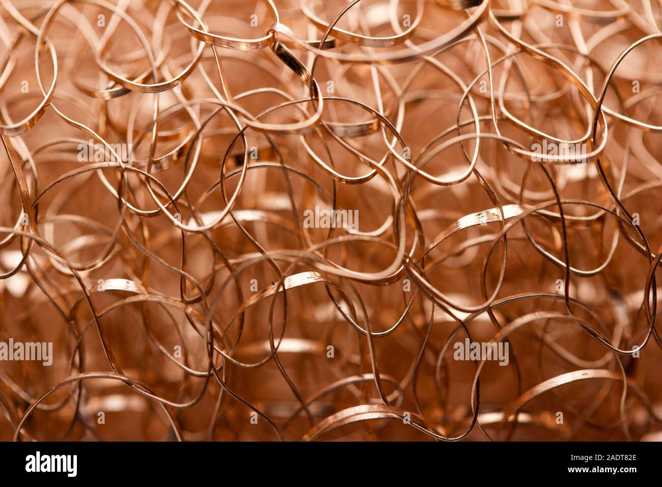 Artistic abstract background view of a macro photographed bright copper ...