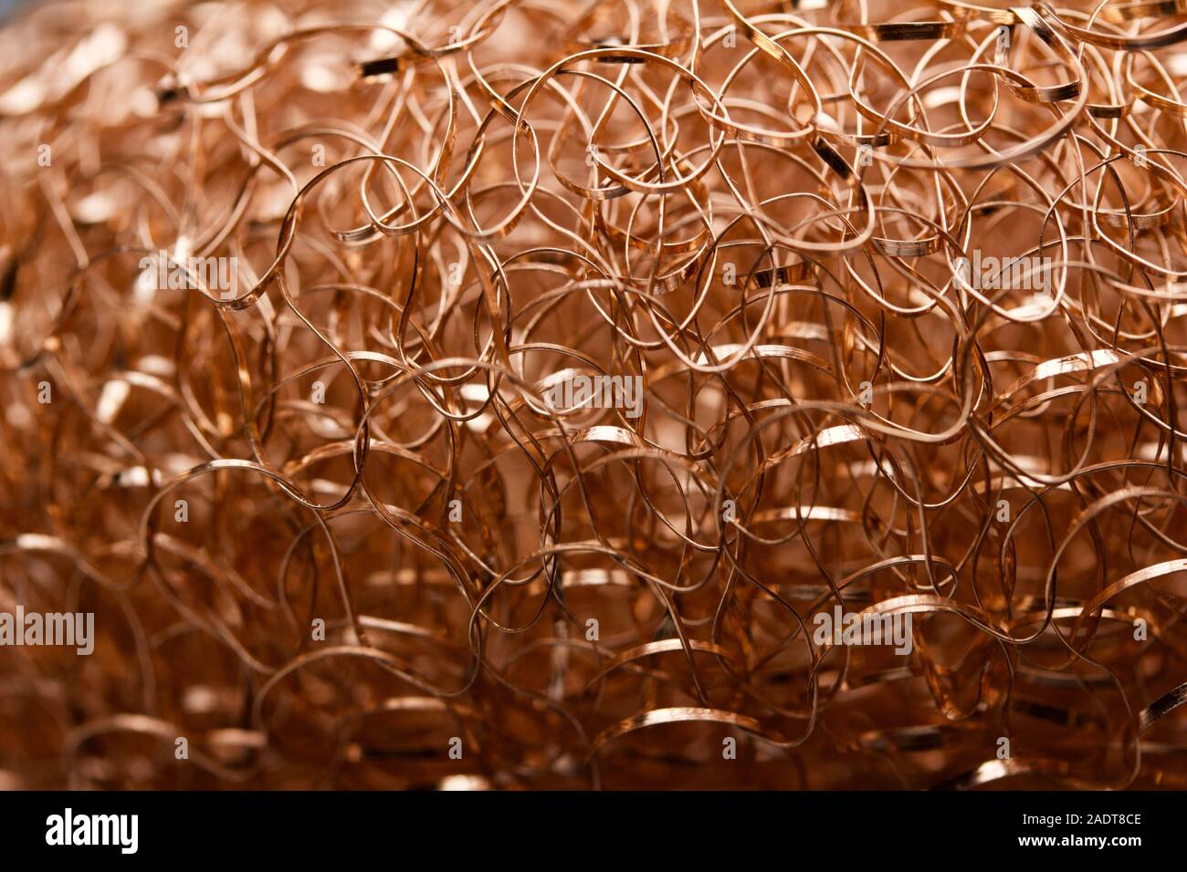 Artistic abstract background view of a macro photographed bright copper ...