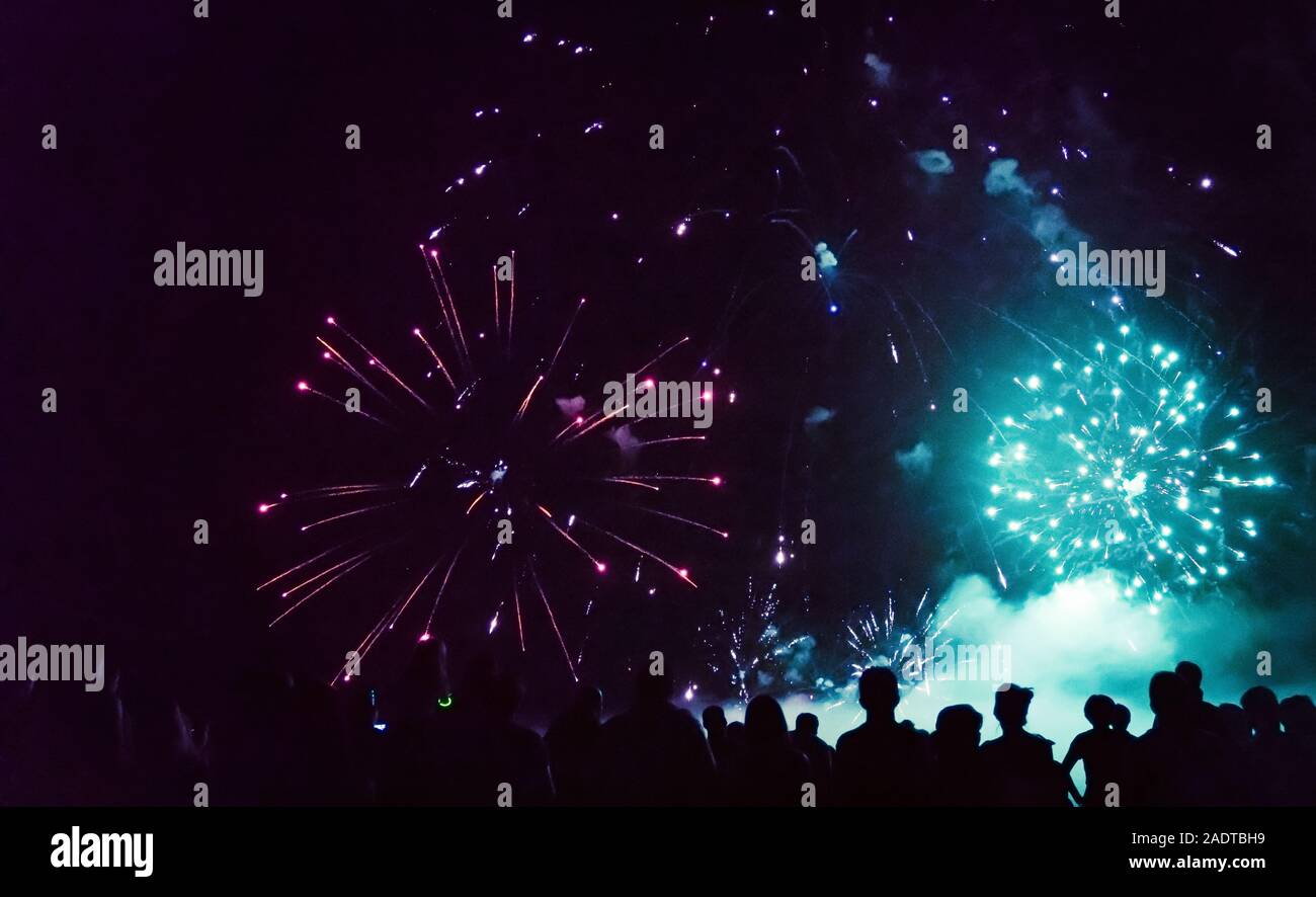 New year concept - cheering crowd and fireworks Stock Photo - Alamy