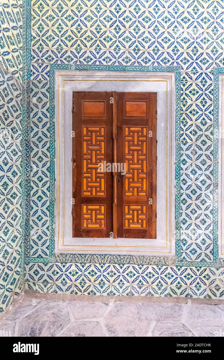 Wood door and windows with wooden shutters on peach colored wall at ...