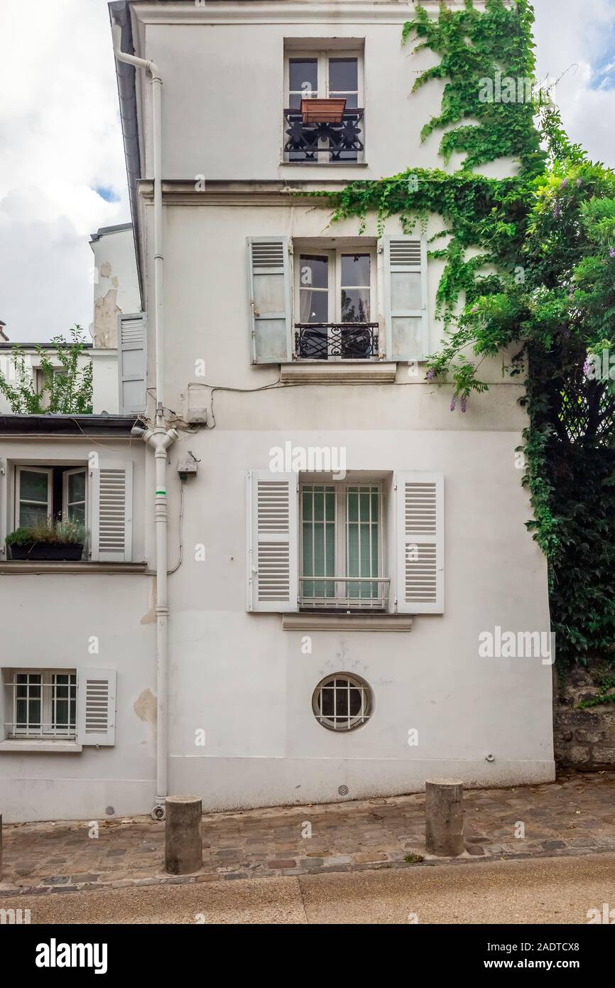 Wood door and windows with wooden shutters on peach colored wall at ...