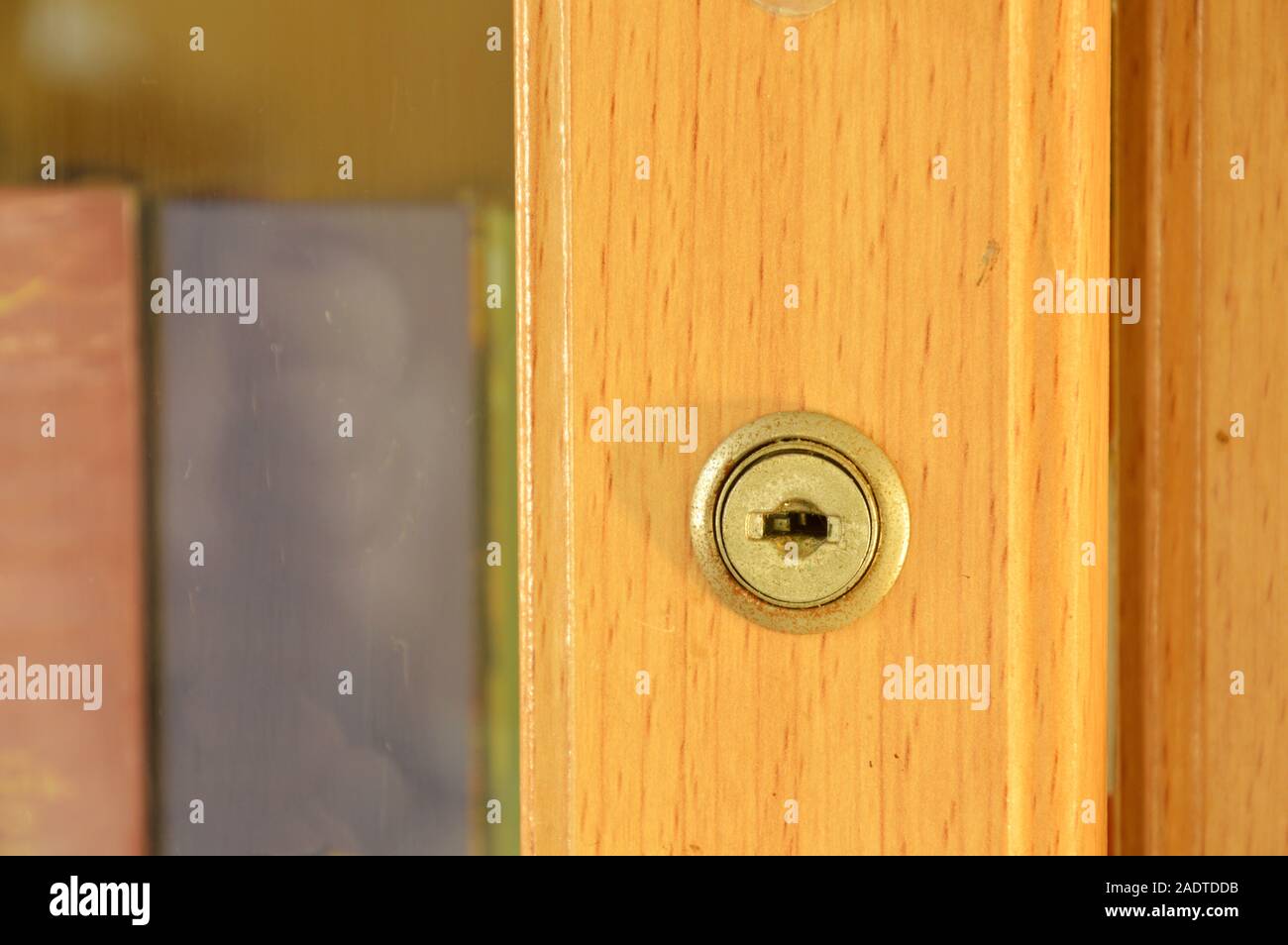 keyhole on door of wooden bookcase Stock Photo - Alamy