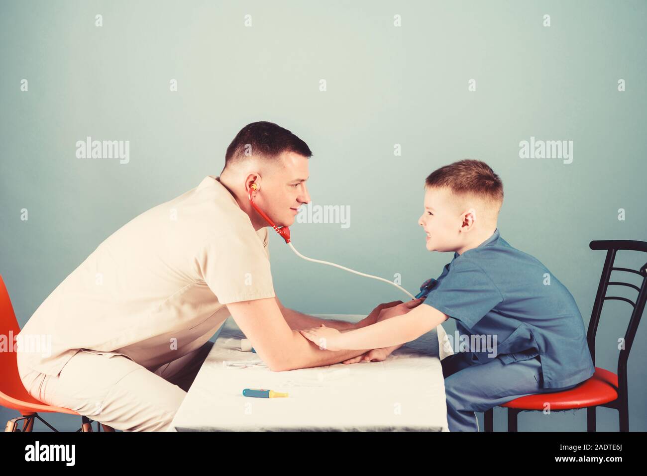 professional talk. medicine and health. small boy with dad play. Future ...
