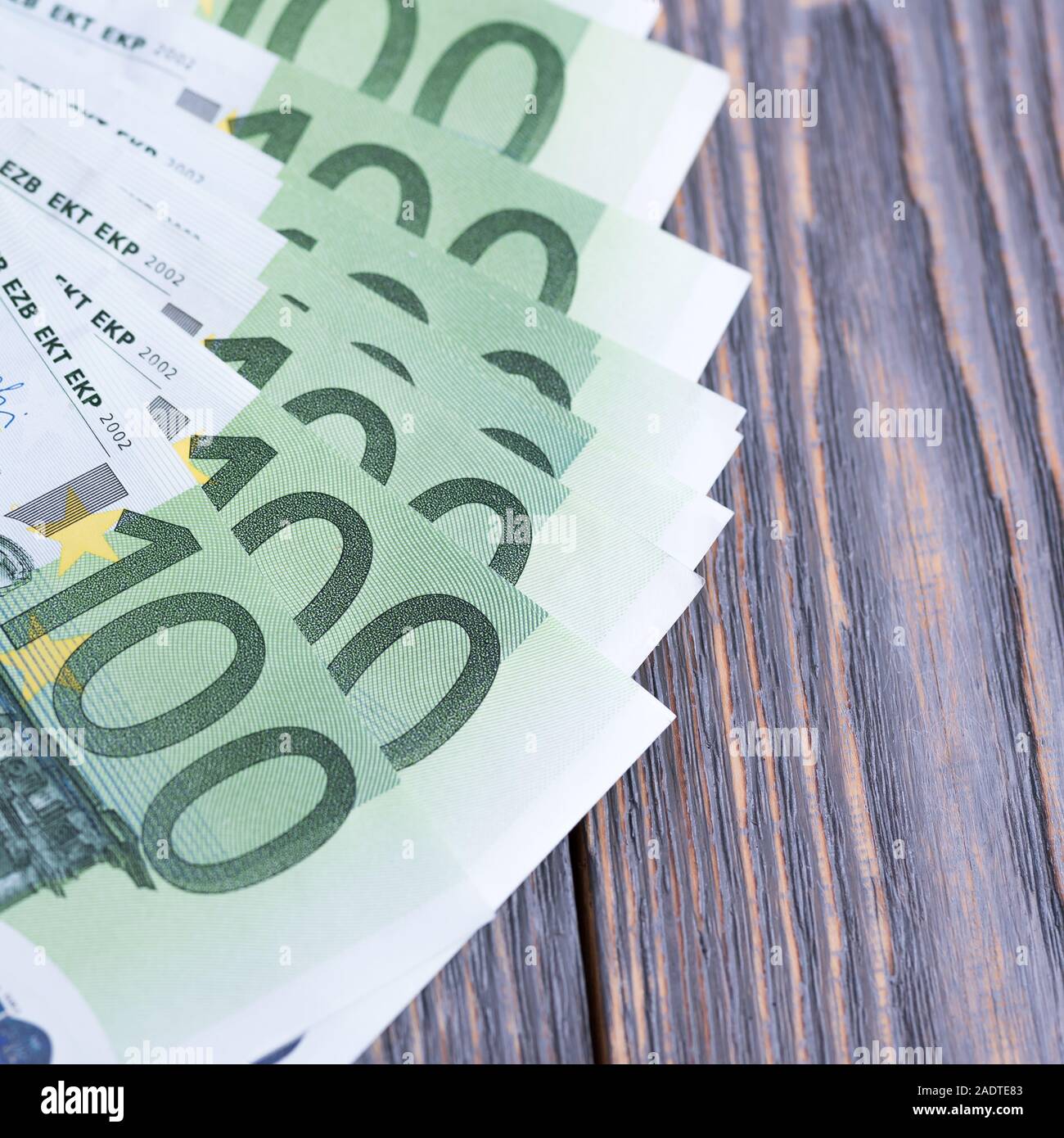 Euro banknotes in fan at wooden background Stock Photo - Alamy