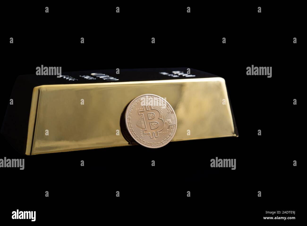 Bitcoin cryptocurrency and gold bar on a black background Stock Photo ...