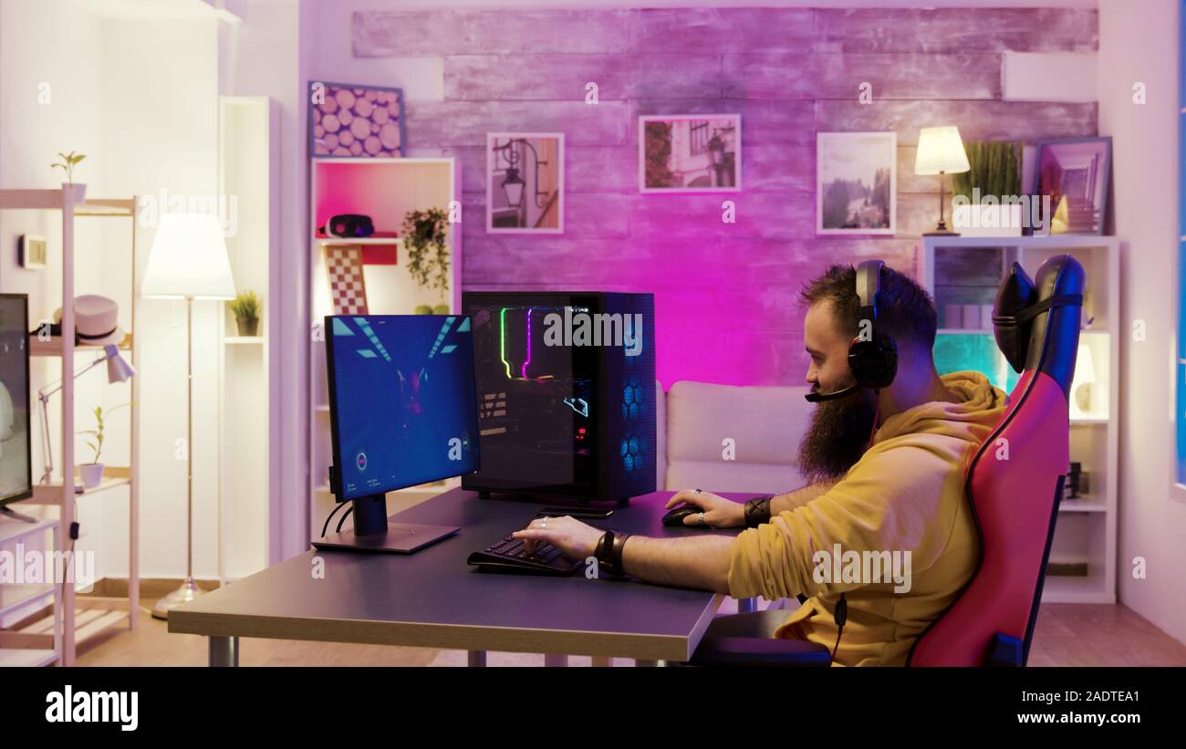 Man relaxing playing video games after a stressful day at work. Room ...