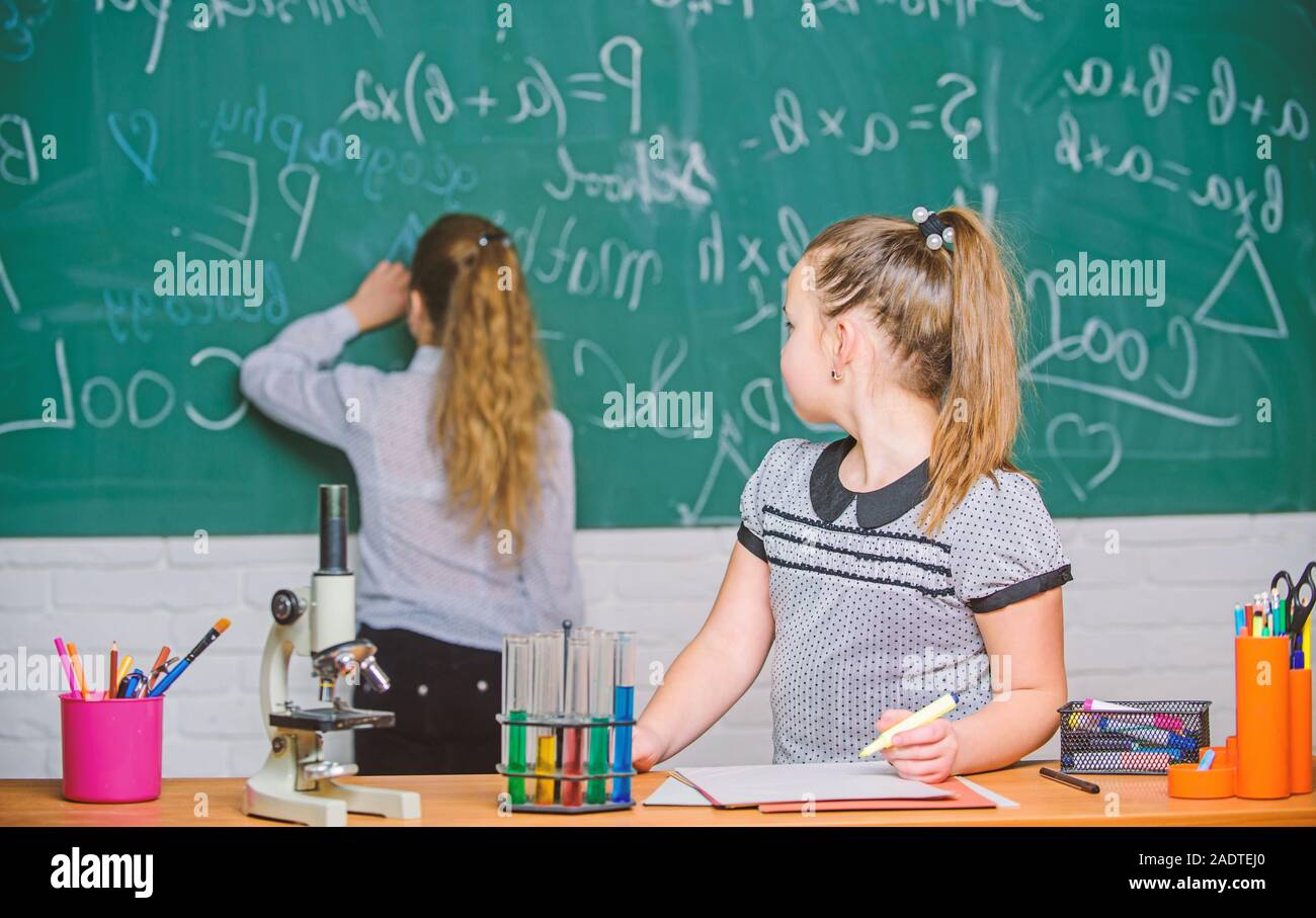 Fascinating science. Educational experiment. Girls classmates study ...