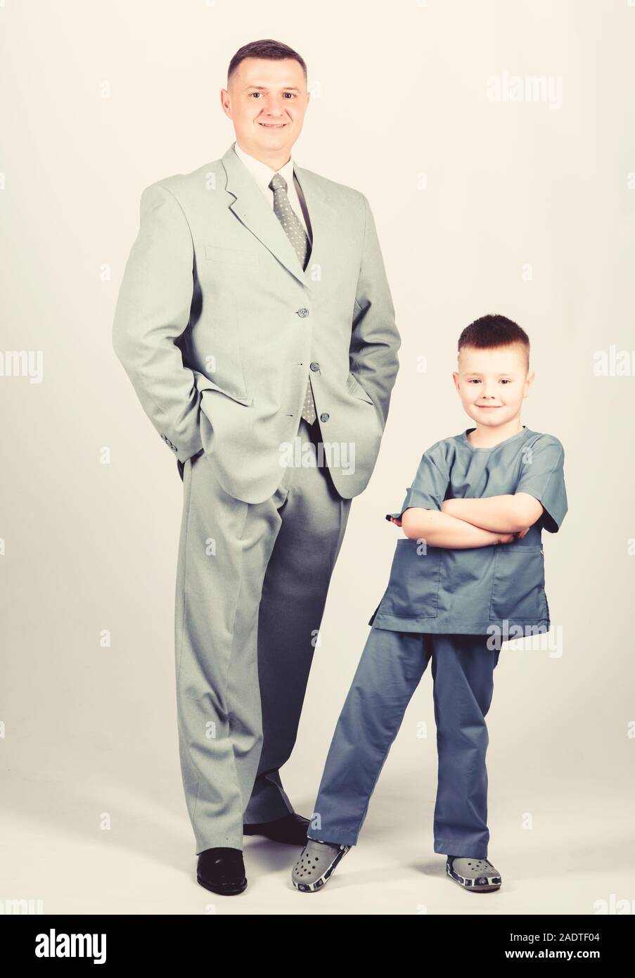 business partner. small boy doctor with dad businessman. childhood ...