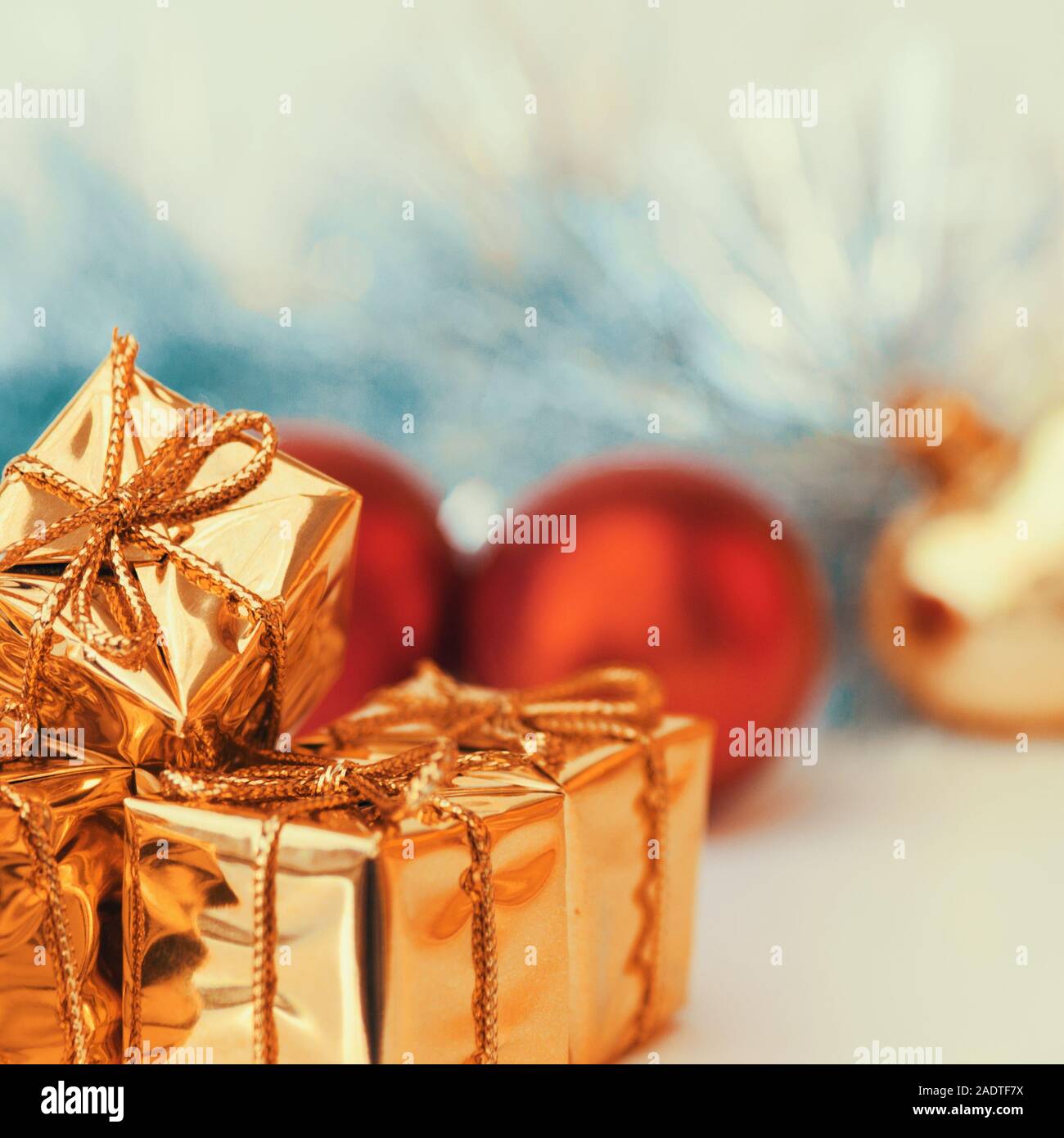 Christmas red balls and gifts in golden boxes Stock Photo - Alamy