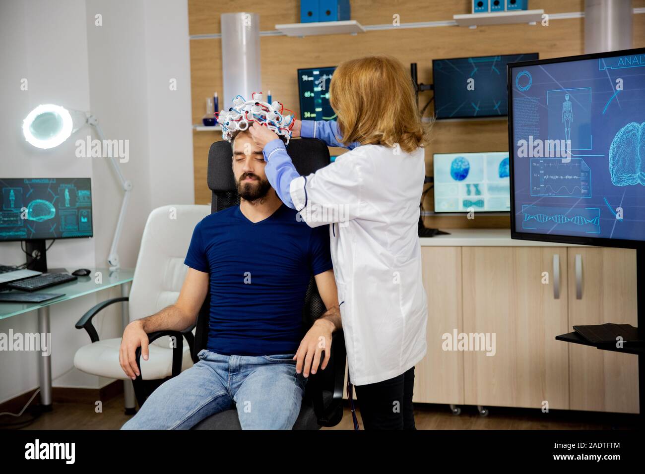 Doctor putting brainwaves scanning headset on male patient. Neurology ...