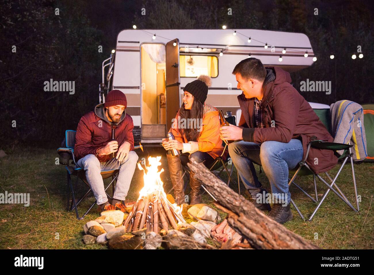 Group of close friends camping together in the mountains relaxing ...