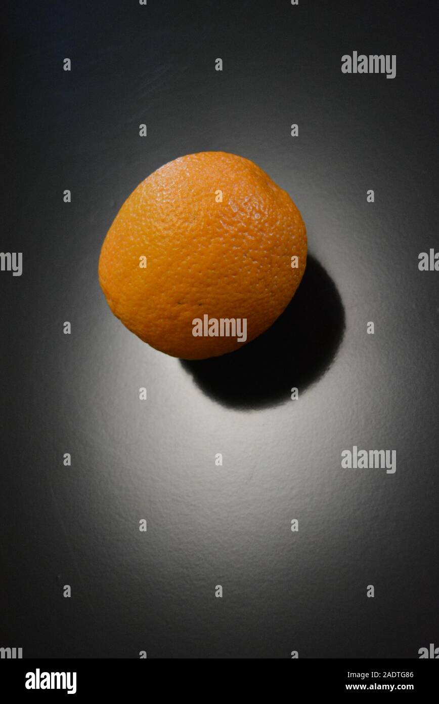 Fresh fruit, one orange orange on a glossy black background Stock Photo ...