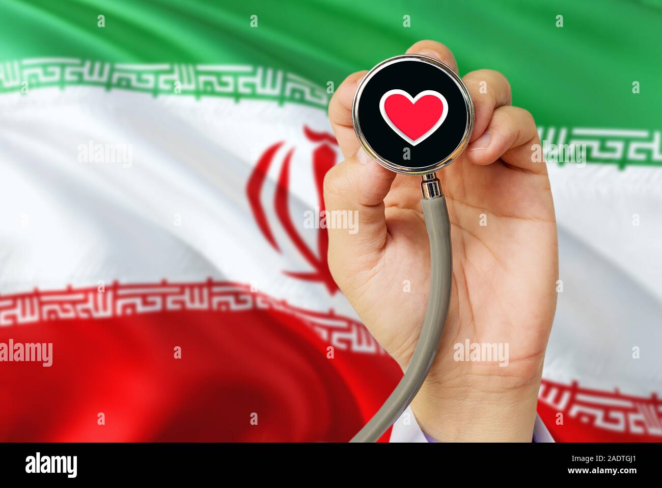 Doctor holding stethoscope with red love heart. National Iran flag ...
