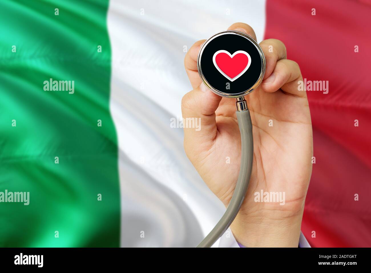 Doctor holding stethoscope with red love heart. National Italy flag ...
