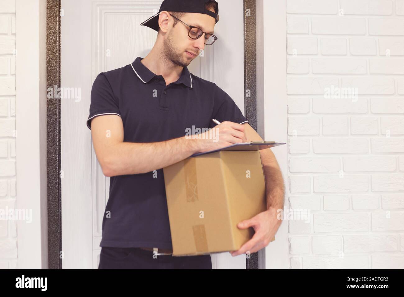 Postman delivering parcel hi-res stock photography and images - Alamy