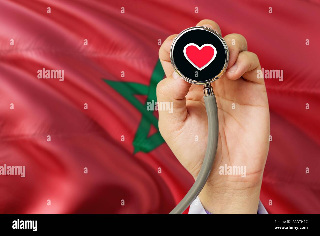 Doctor holding stethoscope with red love heart. National Morocco flag ...