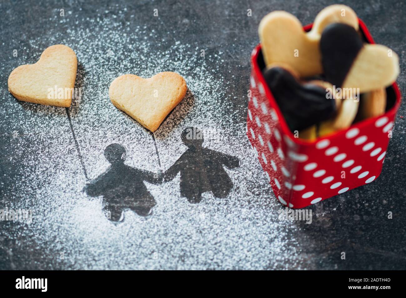 Heart shaped cookies and loving couple shape contour of white sugar on ...