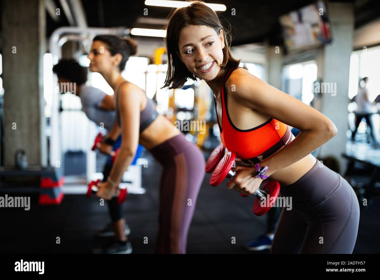 Beautiful fit people working out in gym together Stock Photo - Alamy