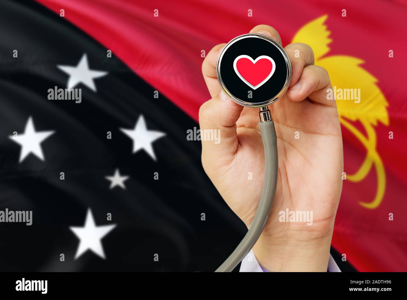 Doctor holding stethoscope with red love heart. National Papua New ...
