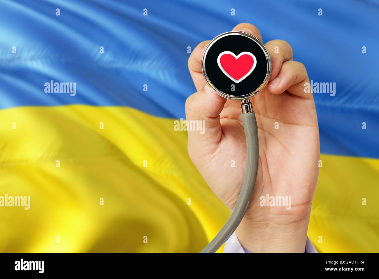 Doctor holding stethoscope with red love heart. National Ukraine flag ...