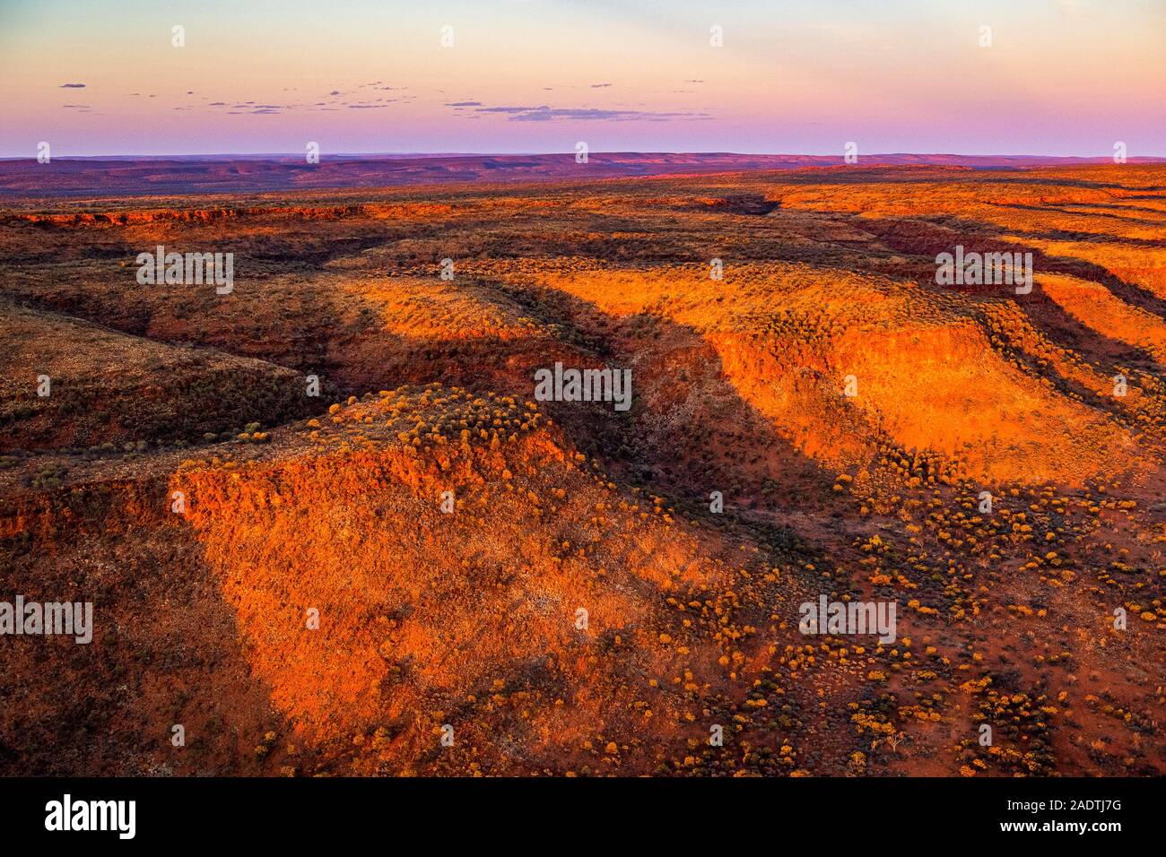 The spectacular George Gill Range at sunset from an aerial perspective ...