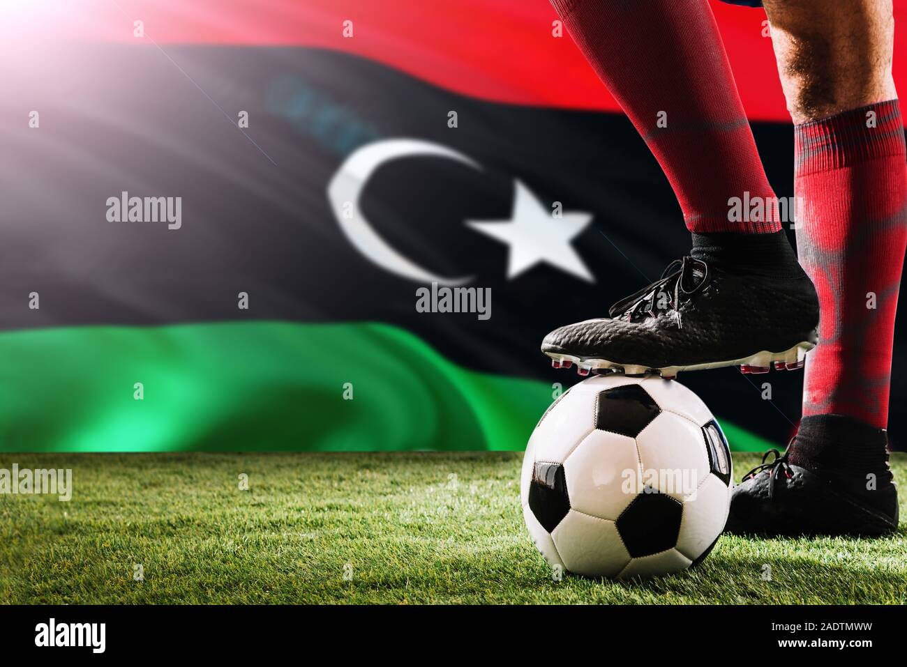 Close up legs of Libya football team player in red socks, shoes on ...