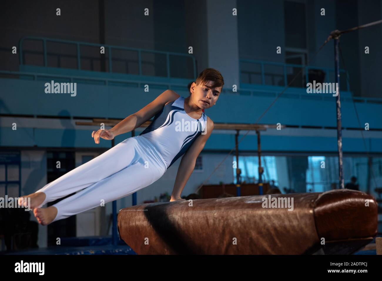 Little male gymnast training in gym, flexible and active. Caucasian fit ...