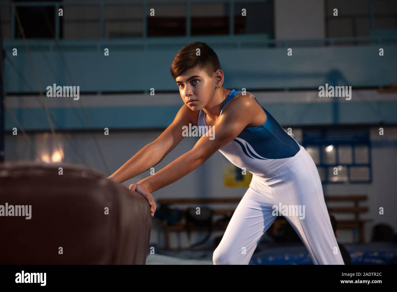 Little male gymnast training in gym, flexible and active. Caucasian fit ...