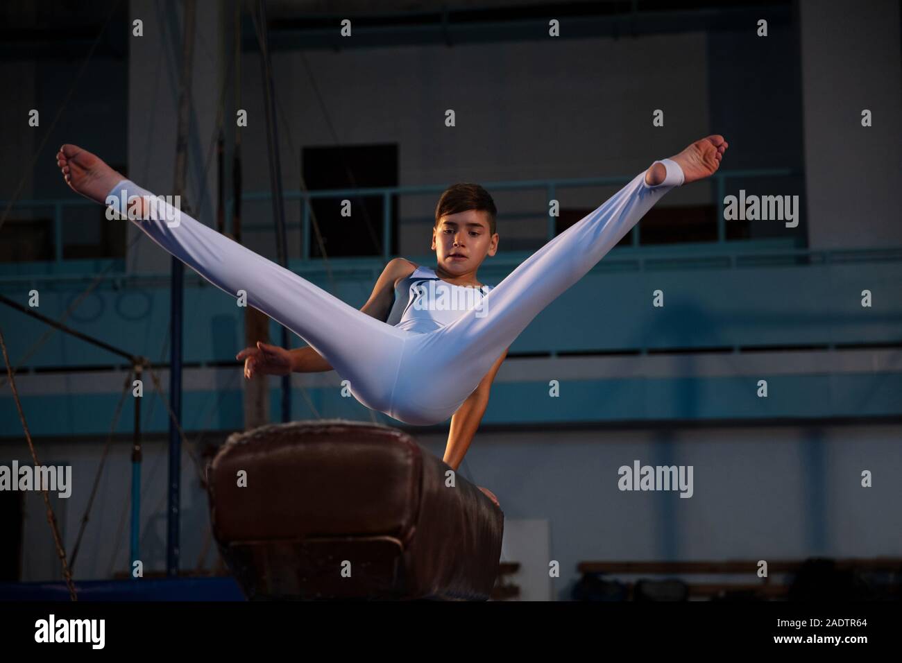 Little male gymnast training in gym, flexible and active. Caucasian fit ...