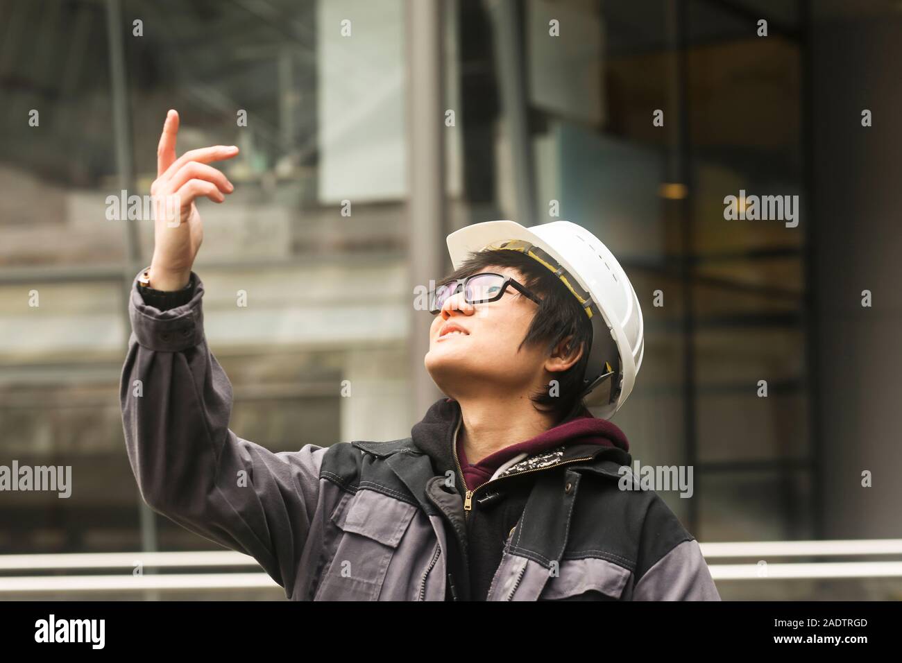Young asian engineer in helmet hi-res stock photography and images - Alamy