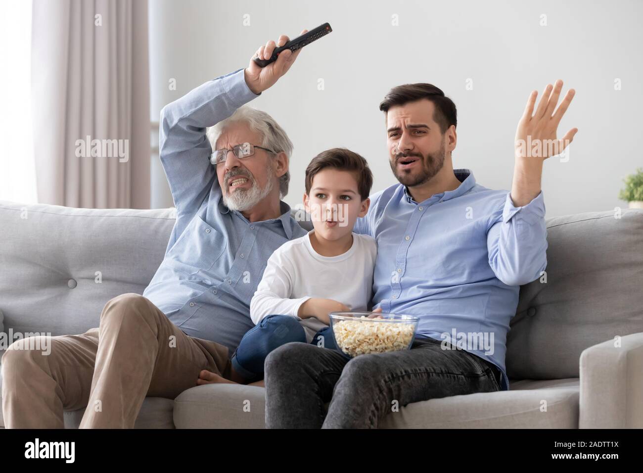 Three generations family watching tv hi-res stock photography and ...