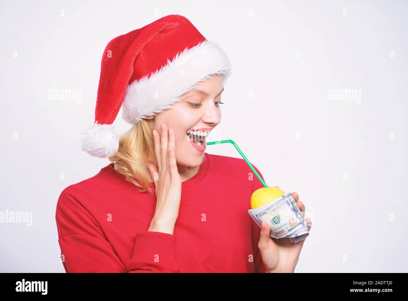 Lemon money concept. Girl santa hat drink juice lemon wrapped in ...