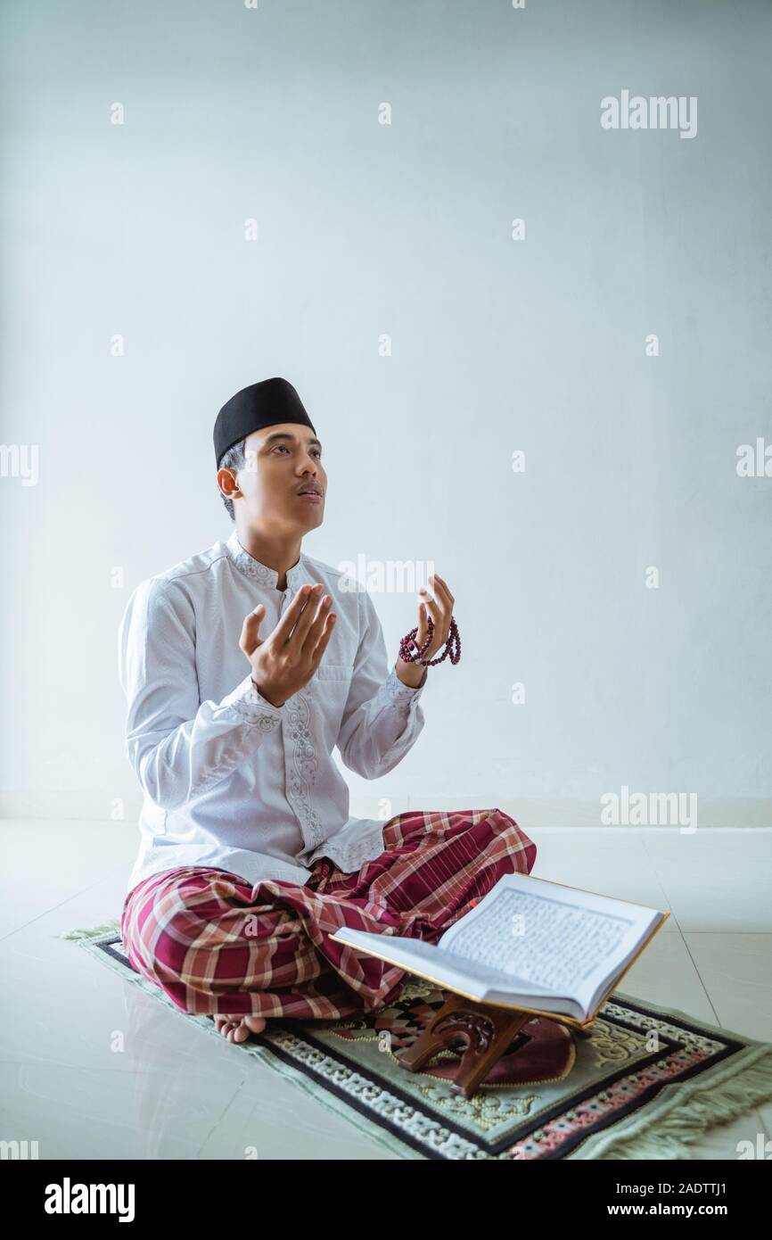 muslim asian man praying to god Stock Photo - Alamy