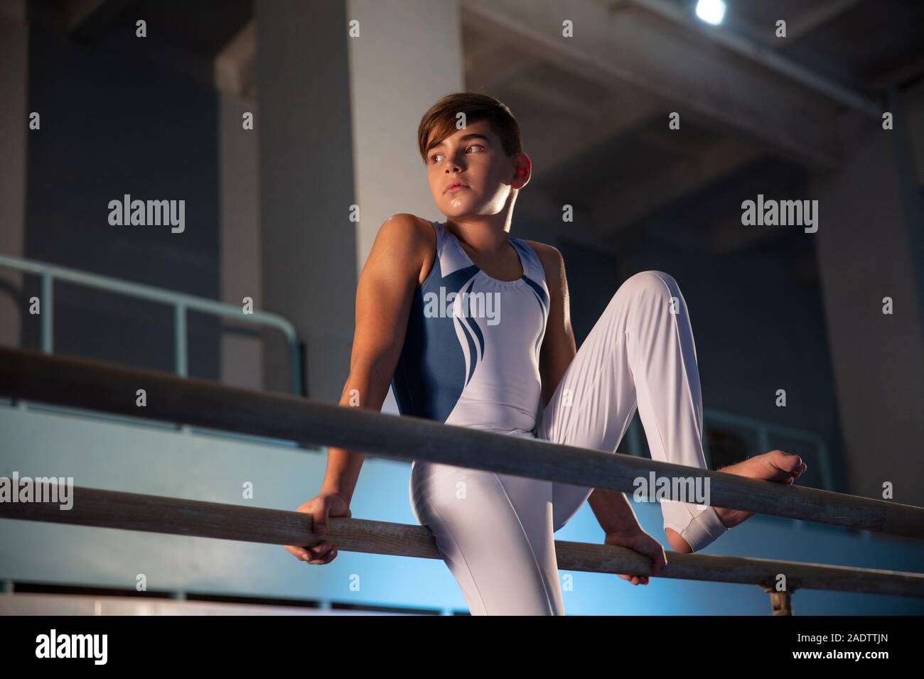 Little male gymnast training in gym, flexible and active. Caucasian fit ...