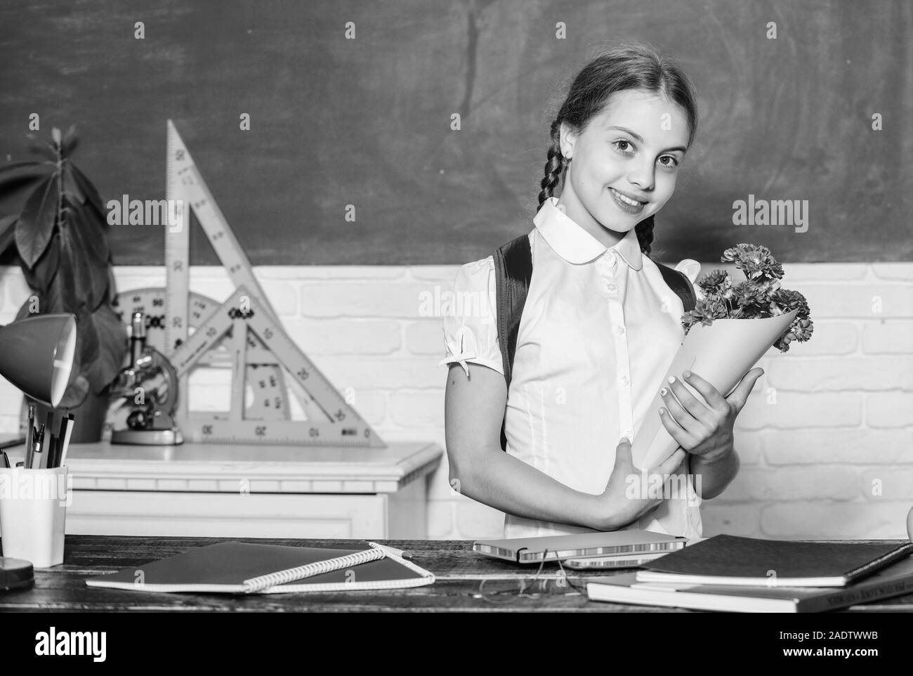 knowledge day is 1 september. small school girl kid with flower bouquet ...