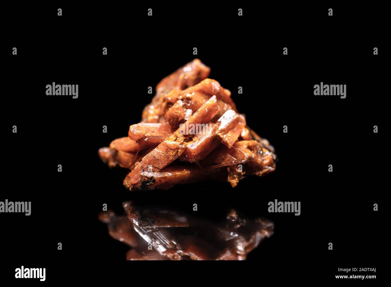 Crocoite mineral stone with reflection in front of black background ...