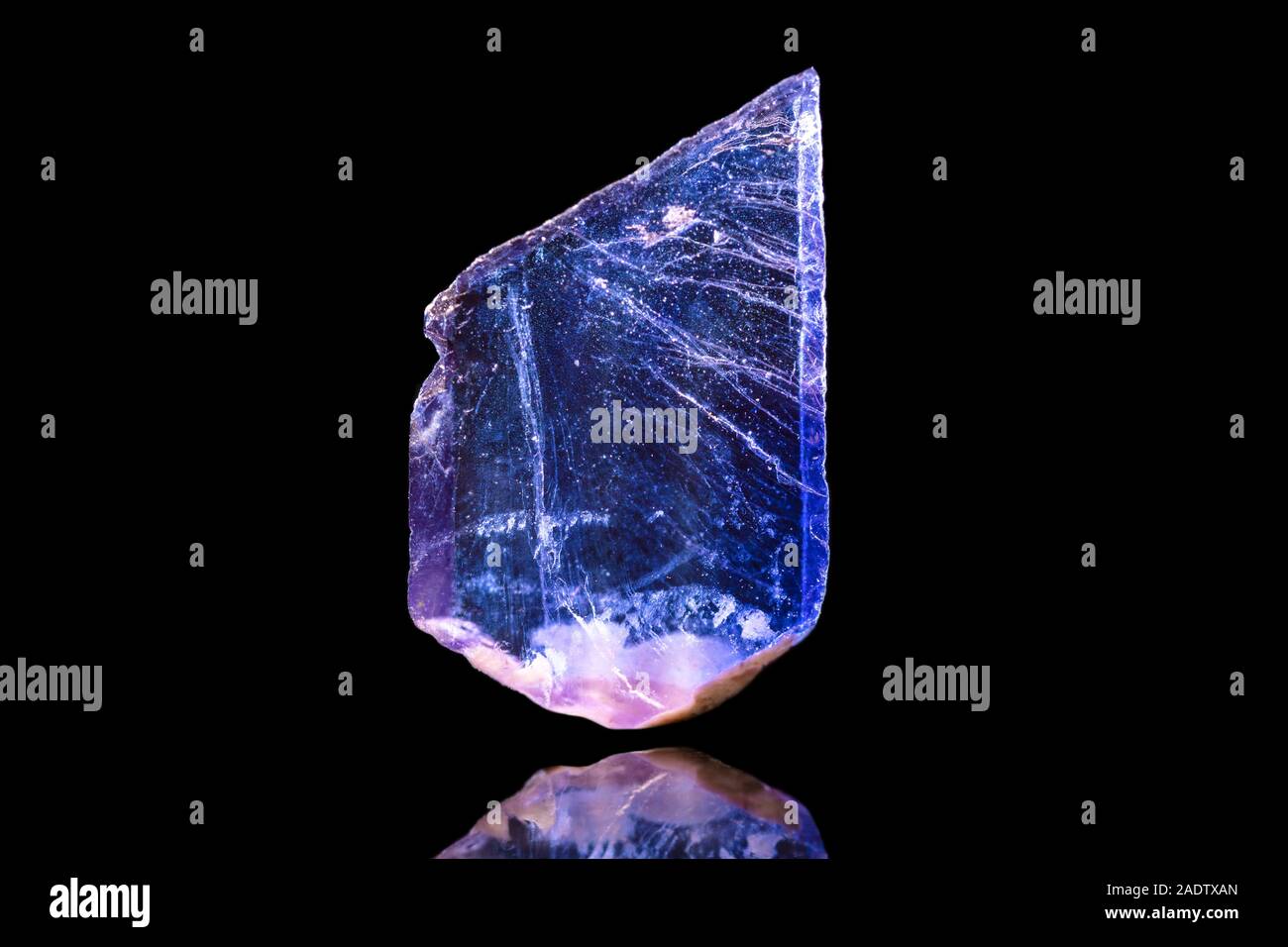 Fluorite or fluorspar mineral in front of black background, raw crystal ...