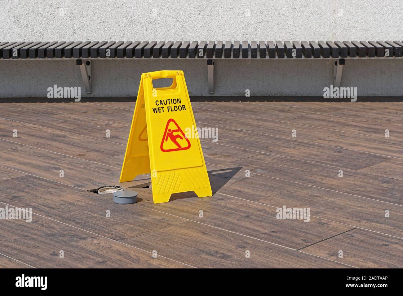 Caution wet floor sign at terrace patio Stock Photo - Alamy