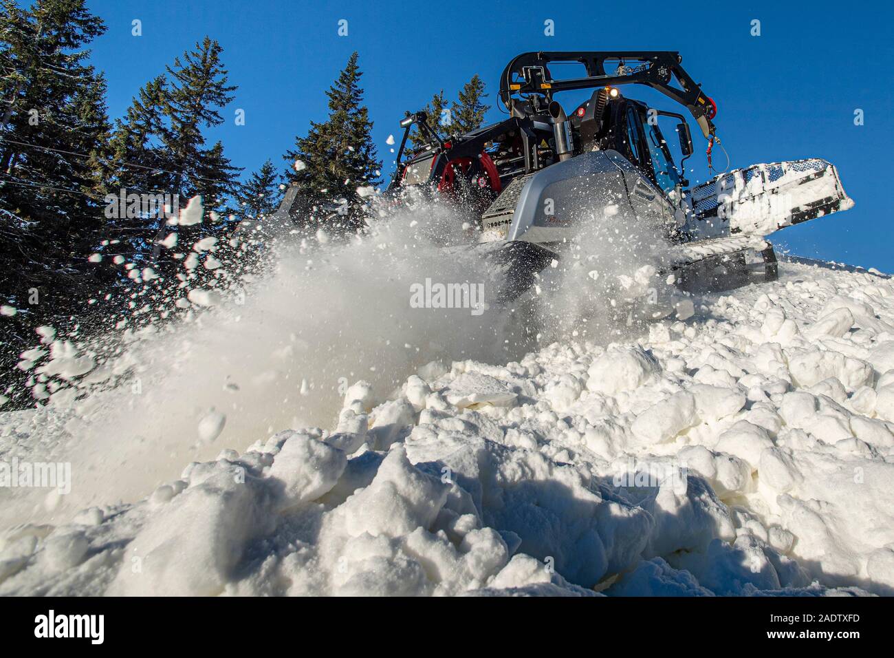 A snowcat moves snow on the Angel (Andel) ski slope during preparations ...