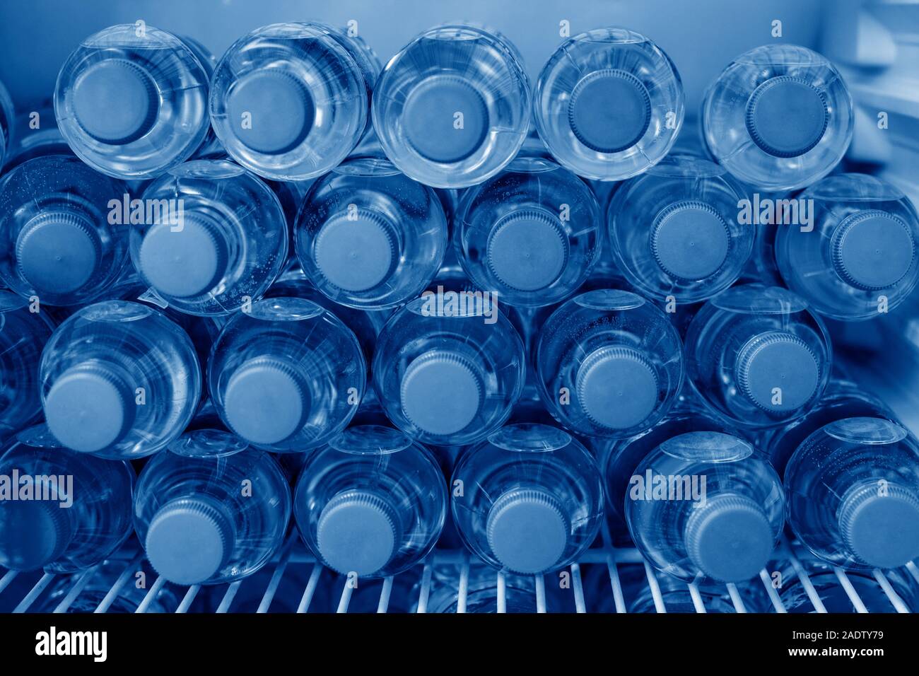 Rows of many transparent plastic bottles with drinking water supply in ...