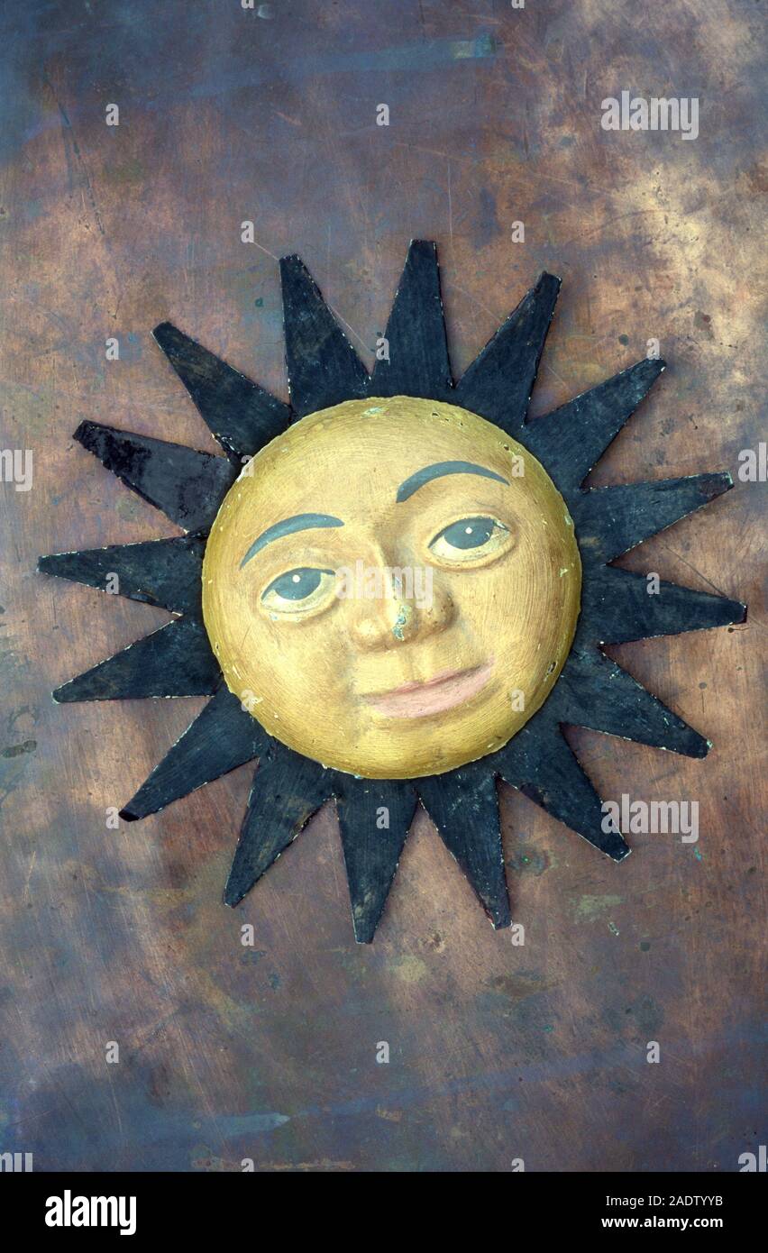 Painted sun face with thoughtful expression and surrounded by black ...