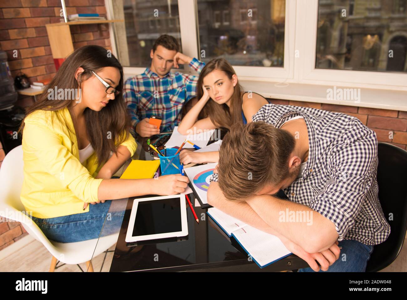 Group of tired students working hard together Stock Photo - Alamy