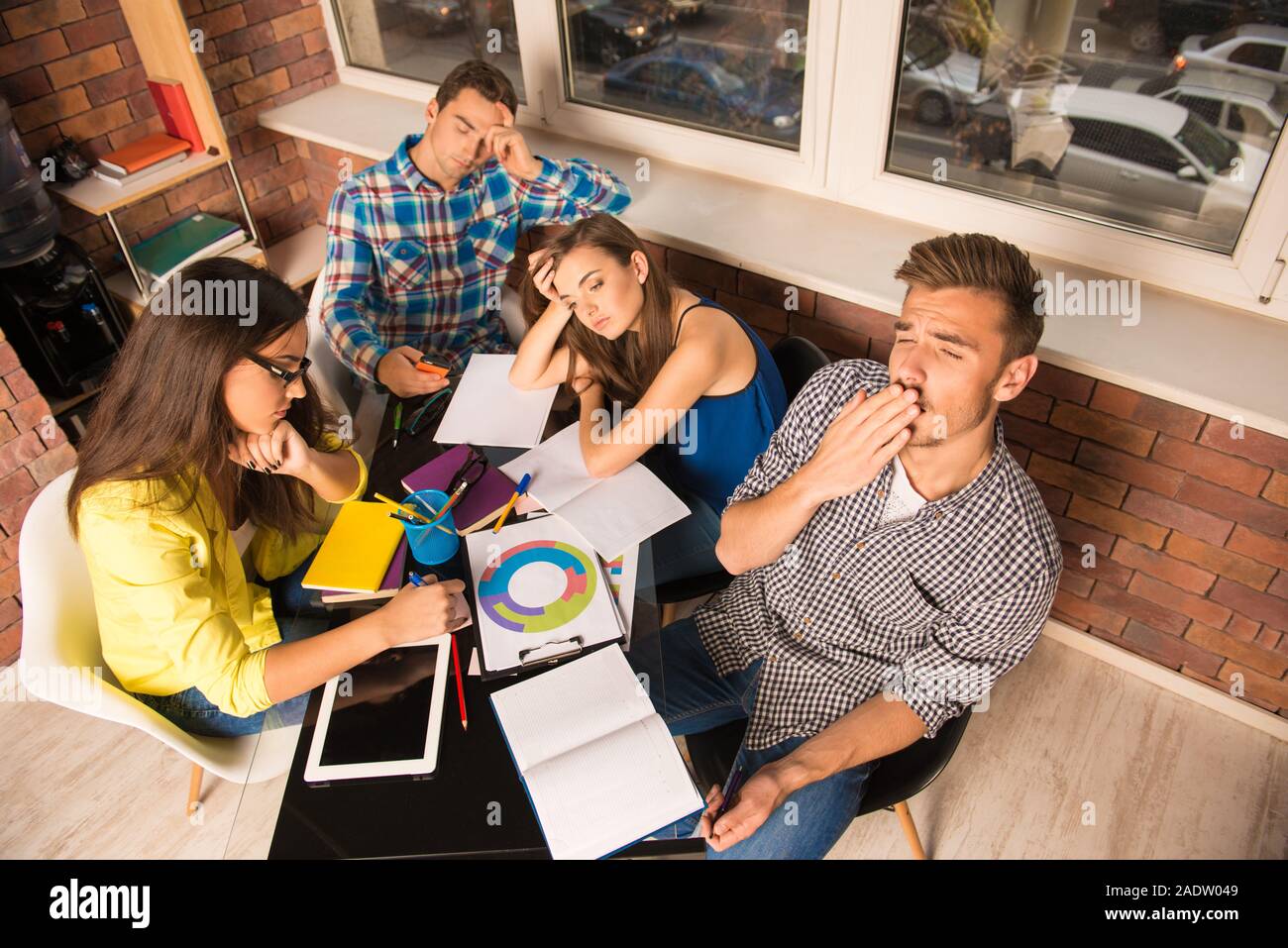 Group of tired students working hard together Stock Photo - Alamy