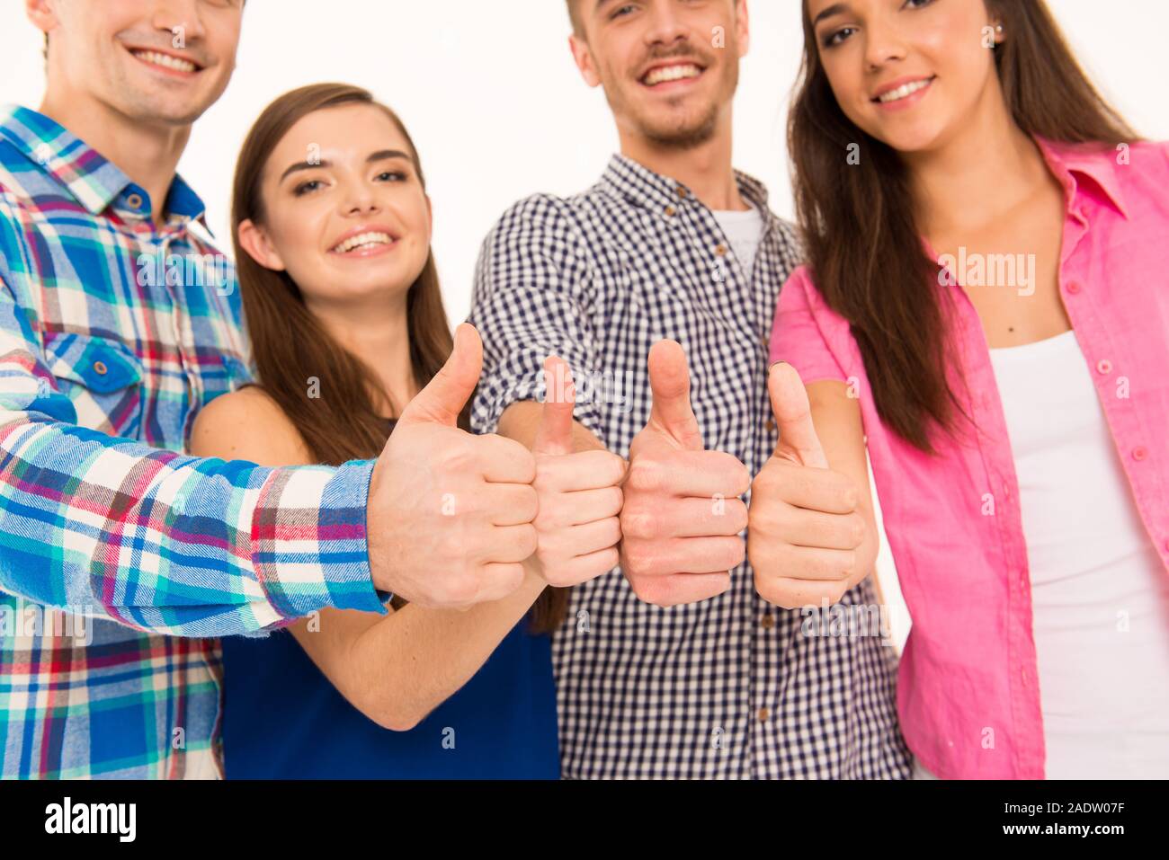 Closeup photo of a cheerful group showing thumbs up Stock Photo - Alamy
