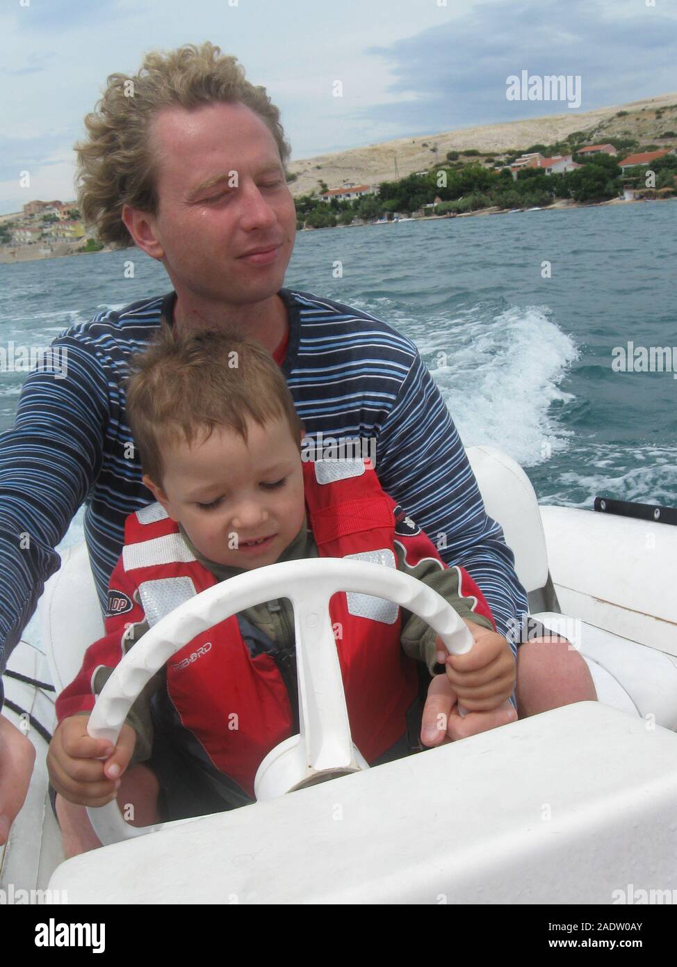 Kid driving boat hi-res stock photography and images - Alamy