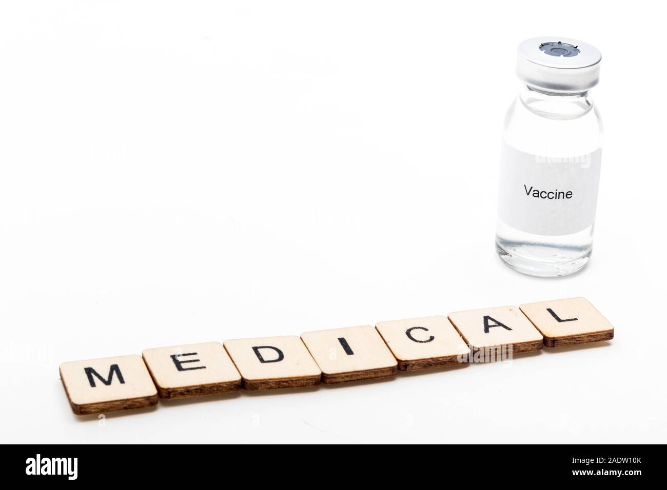 Vaccine concept showing a medical vial with a Vaccine label on a white ...
