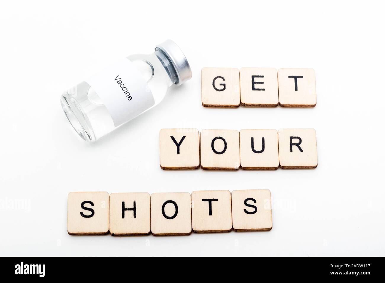 Vaccine concept showing a medical vial with a Vaccine label on a white ...